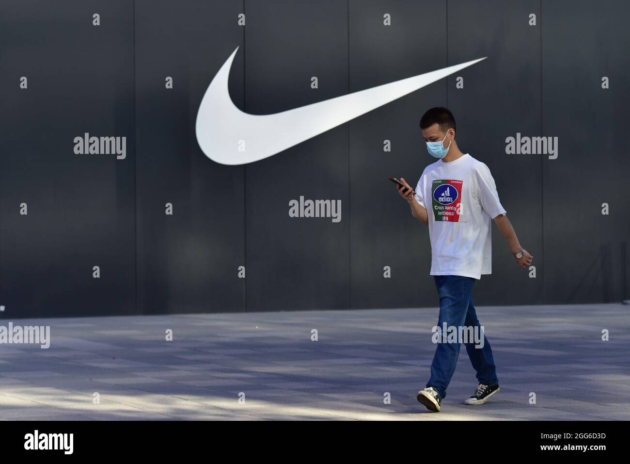 BEIJING, CHINA - AUGUST 27, 2021 - People pass in front of the Nike ...