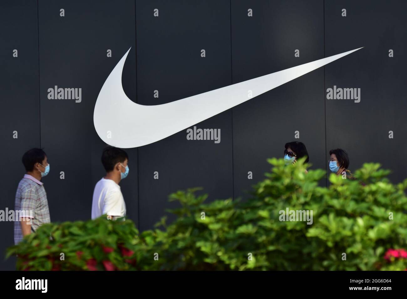 BEIJING, CHINA - AUGUST 27, 2021 - People pass in front of the Nike ...