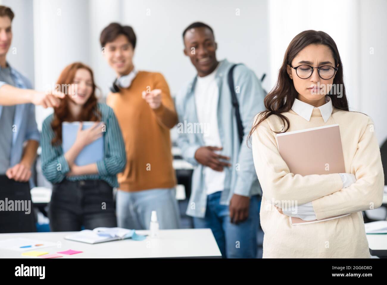 People mocking and making fun of sad woman Stock Photo - Alamy
