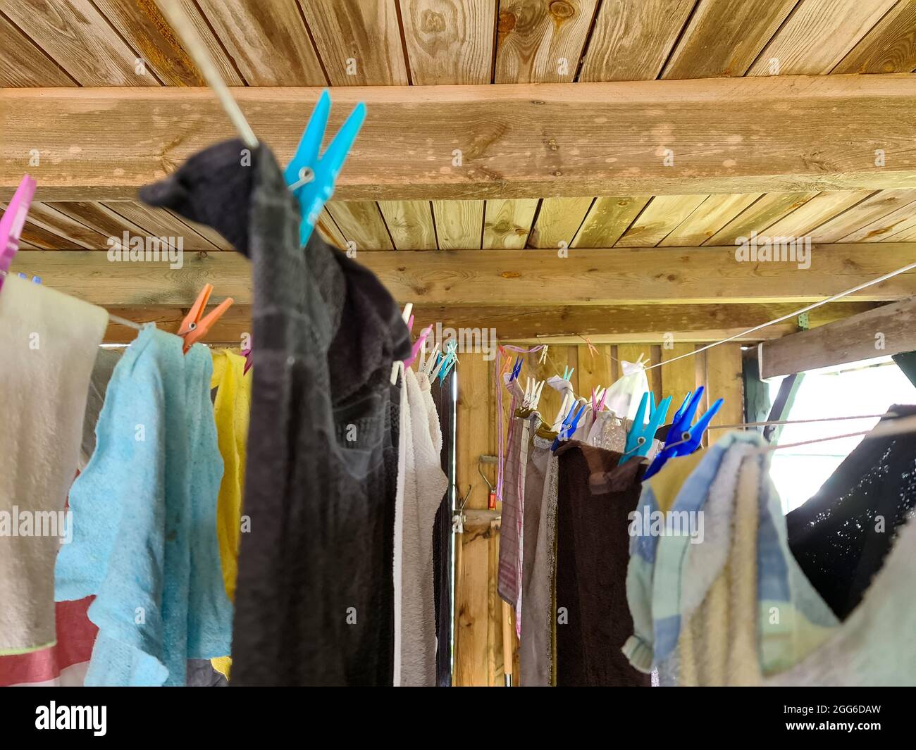 Clothes hung out to dry on a washing line and fastened by the clothes ...