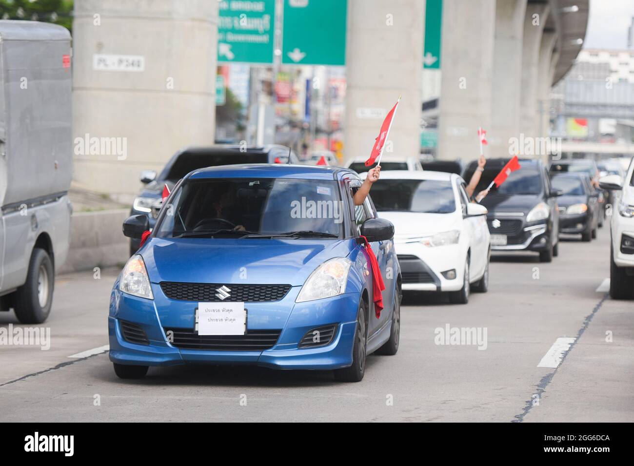 Protesters inside cars wave flags during a car mob rally. Protesters ...