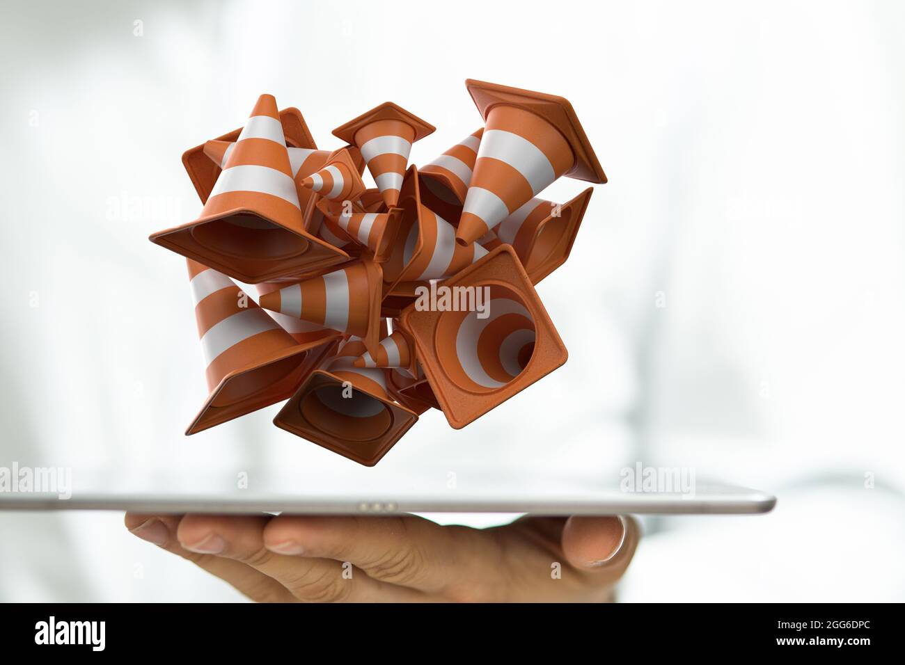 Orange traffic cones floating over the tablet - the concept of website ...