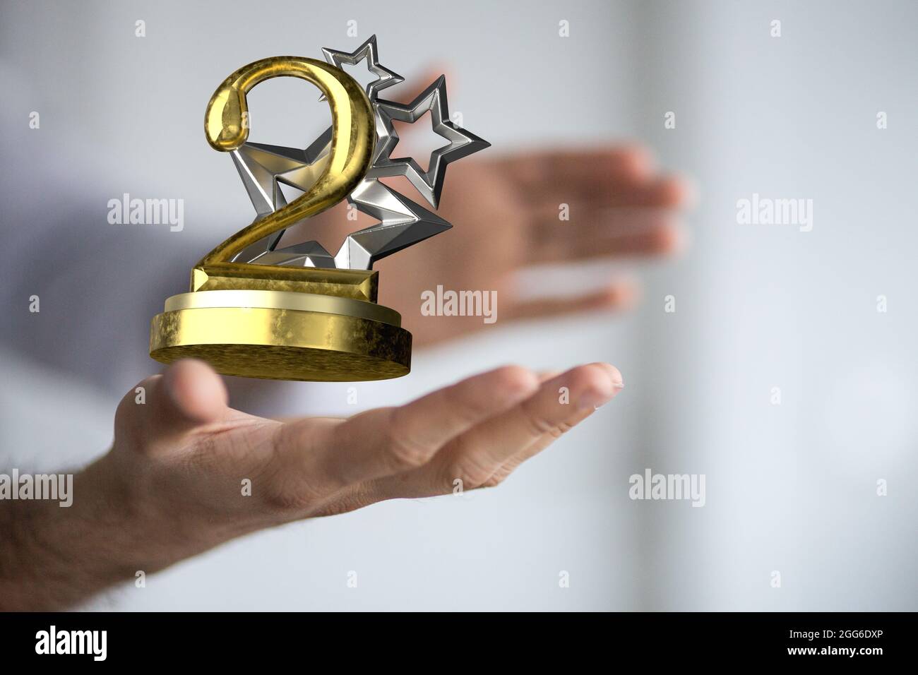 A person touching the gold winner second place trophy Stock Photo - Alamy