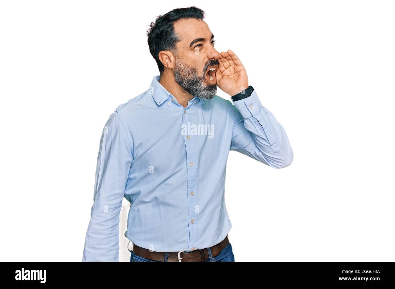 Middle aged man with beard wearing business shirt shouting and ...
