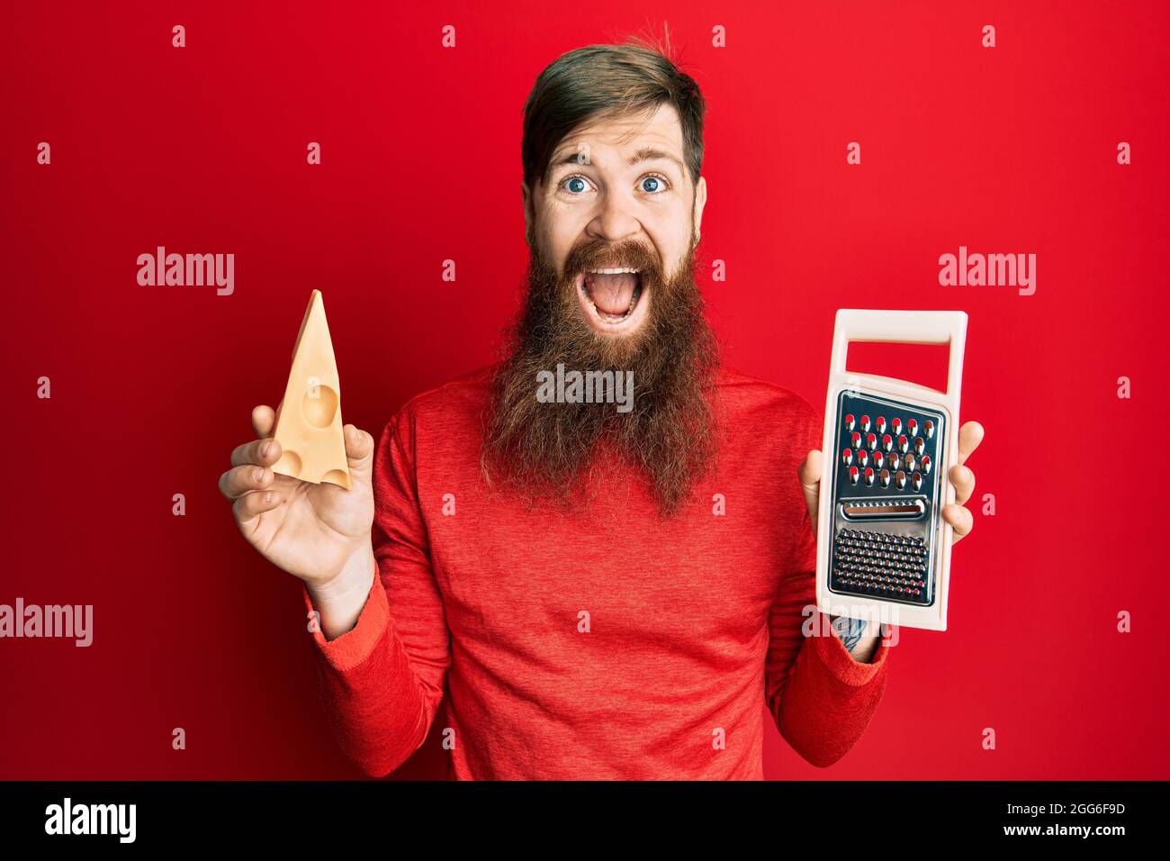 Redhead man with long beard holding grater and cheese celebrating crazy ...