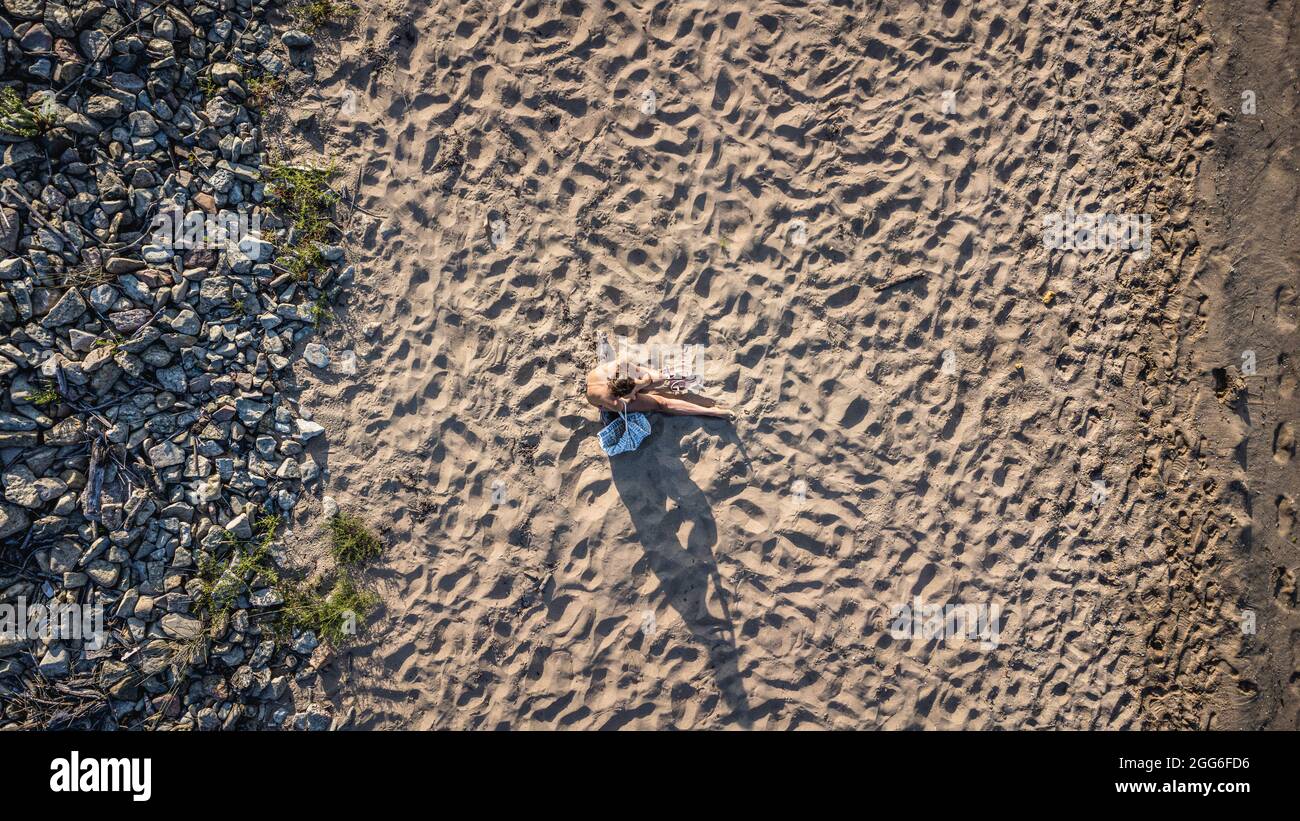 Woman sunbathing on the beach of Arkutino Stock Photo - Alamy