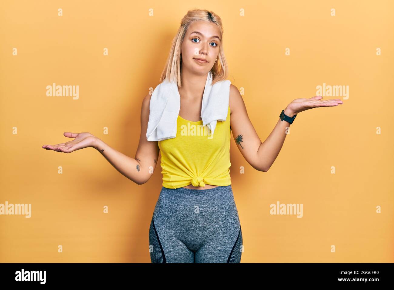 Beautiful blonde sports woman wearing workout outfit clueless and ...