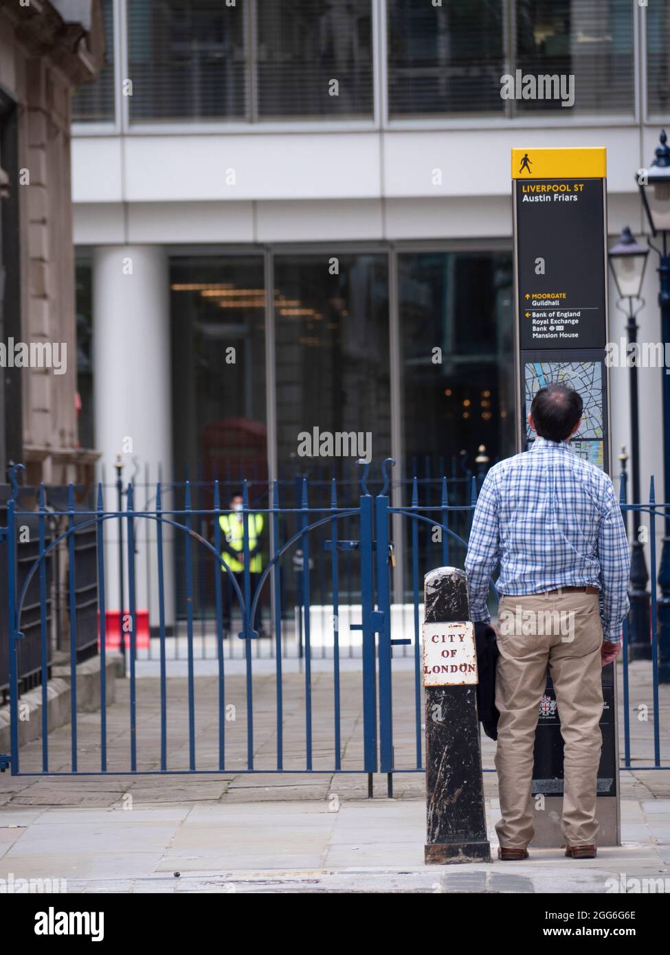Man looking at map of city of London with Blackrock investment company ...