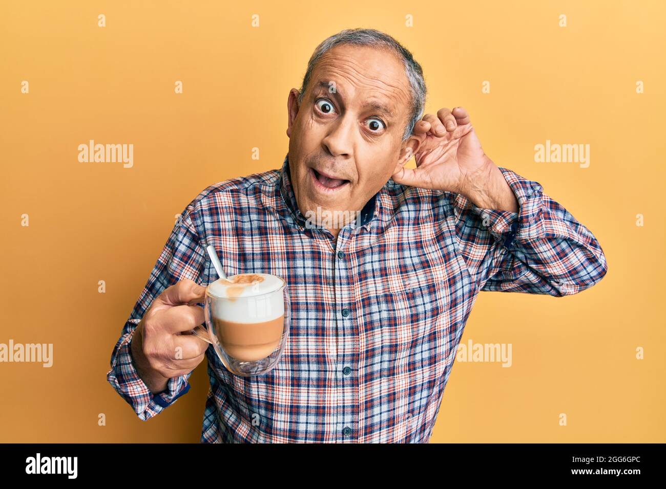 Handsome senior man with grey hair drinking a cup coffee smiling with ...