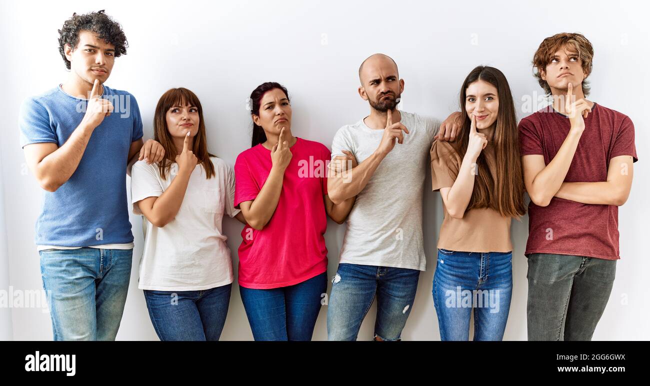 Group of young friends standing together over isolated background ...