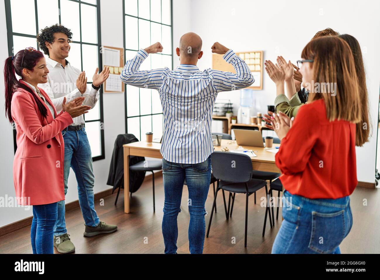 Group of business workers smiling and clapping to partner standing at ...