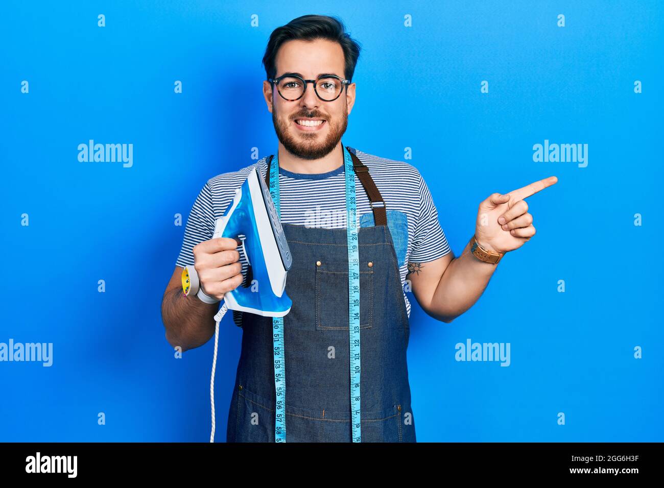 Handsome caucasian man with beard dressmaker designer wearing atelier ...