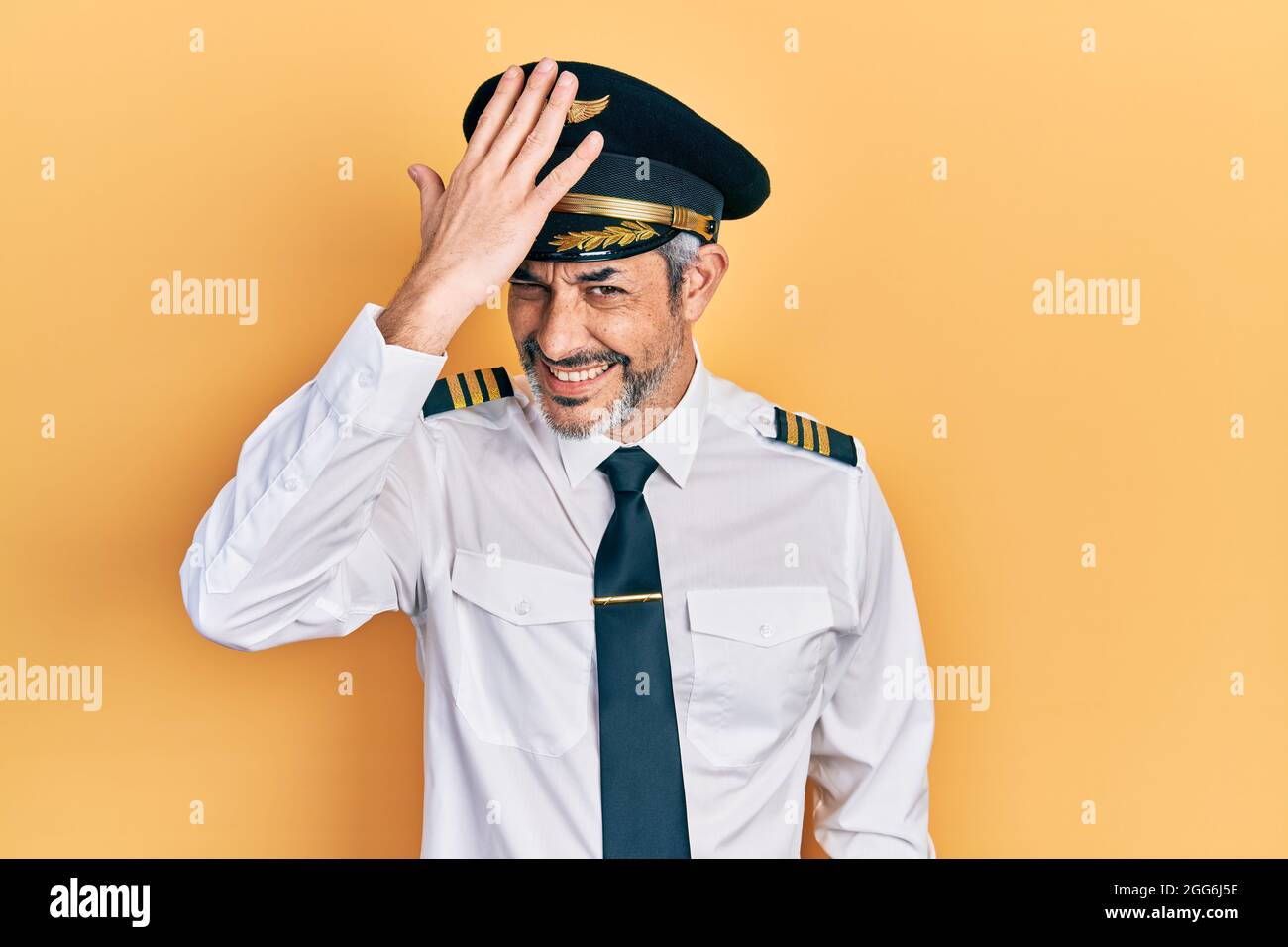 Handsome middle age man with grey hair wearing airplane pilot uniform ...