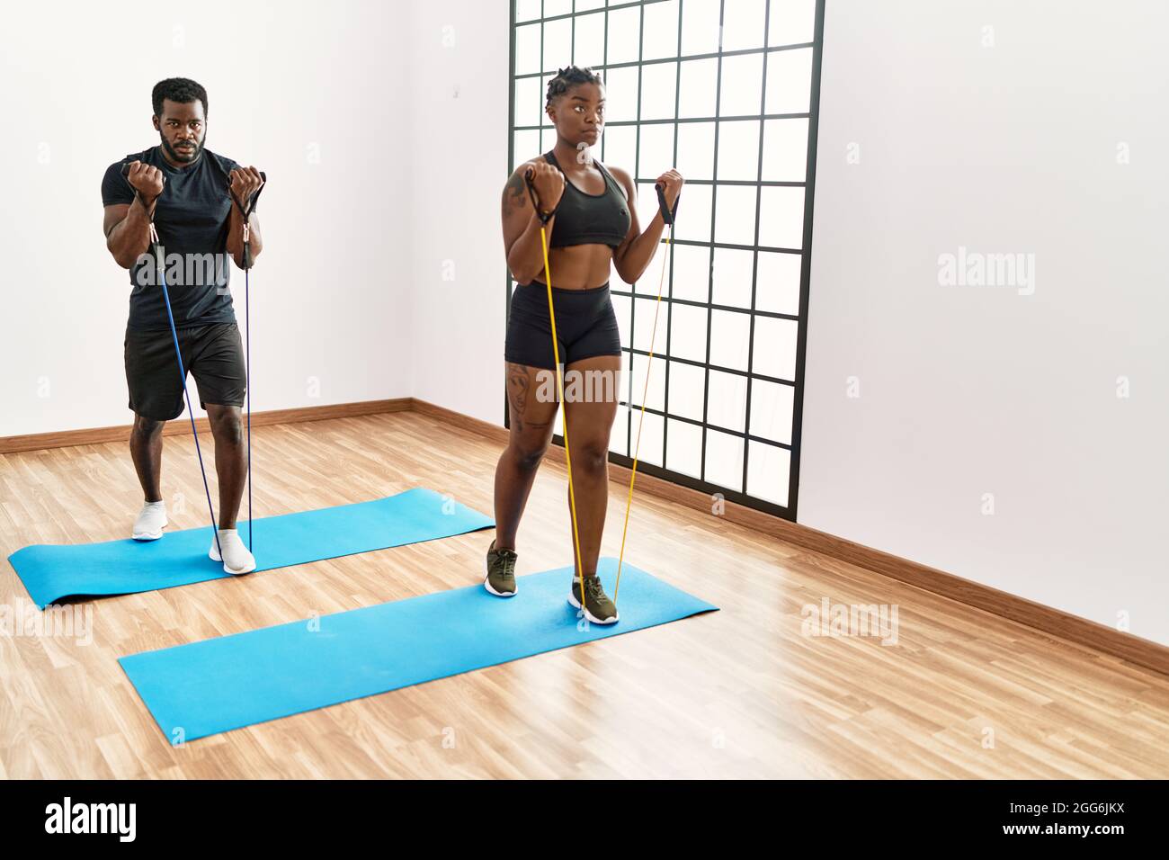 Young african american couple with serious expression training using ...