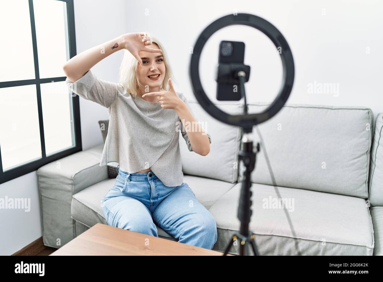 Young caucasian woman recording vlog tutorial with smartphone at home ...