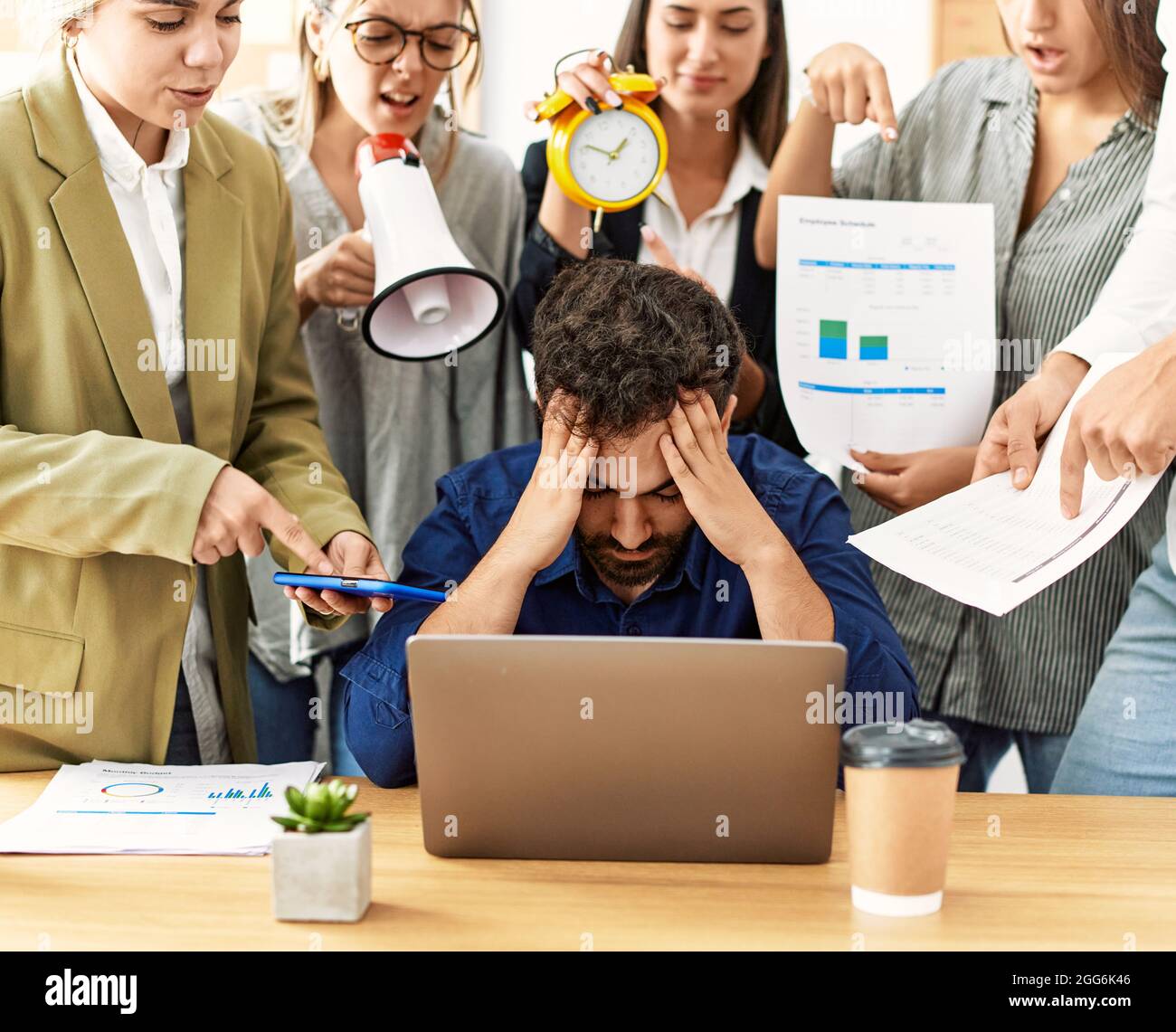 Group of business workers screaming to stressed partner at the office ...