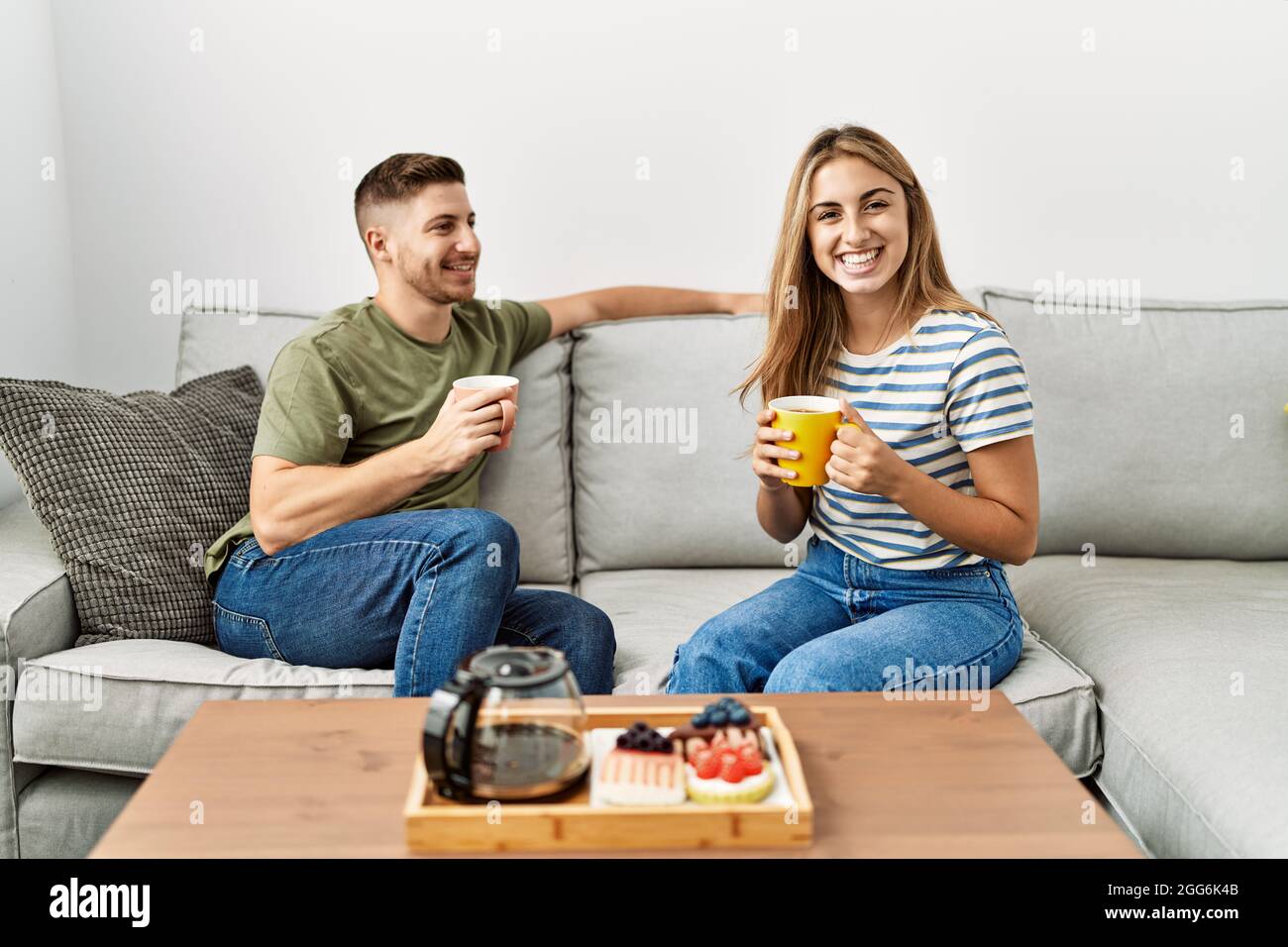 Young hispanic couple smiling happy having breakfast sitting on the ...