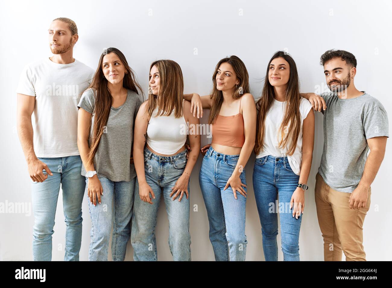Group of young friends standing together over isolated background ...