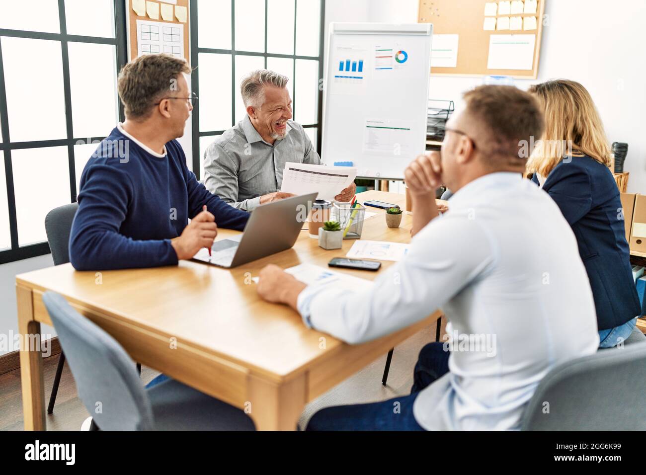 Group of middle age business workers working at the office Stock Photo ...