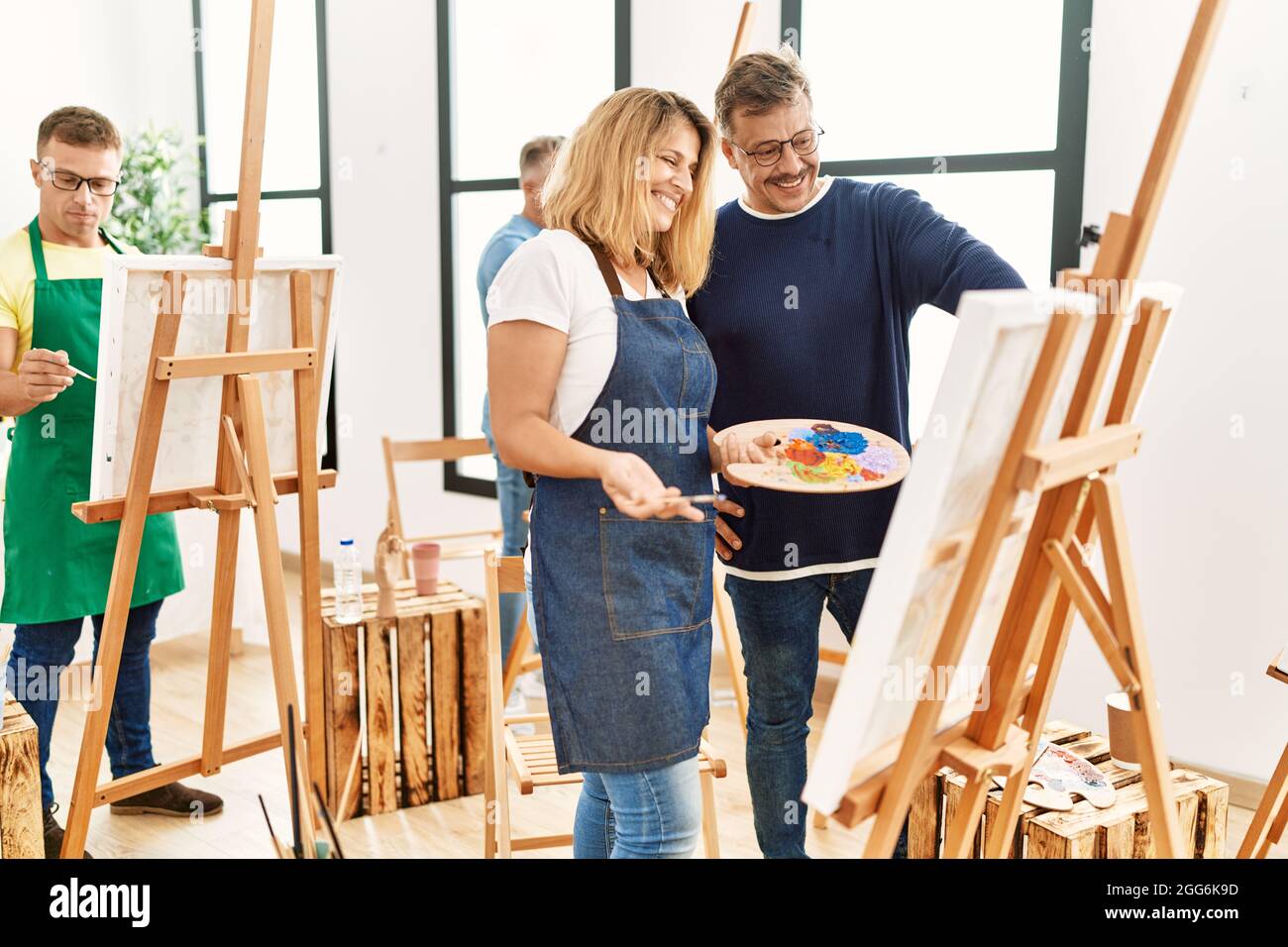 Group of middle age paint students drawing at art studio. Teacher ...