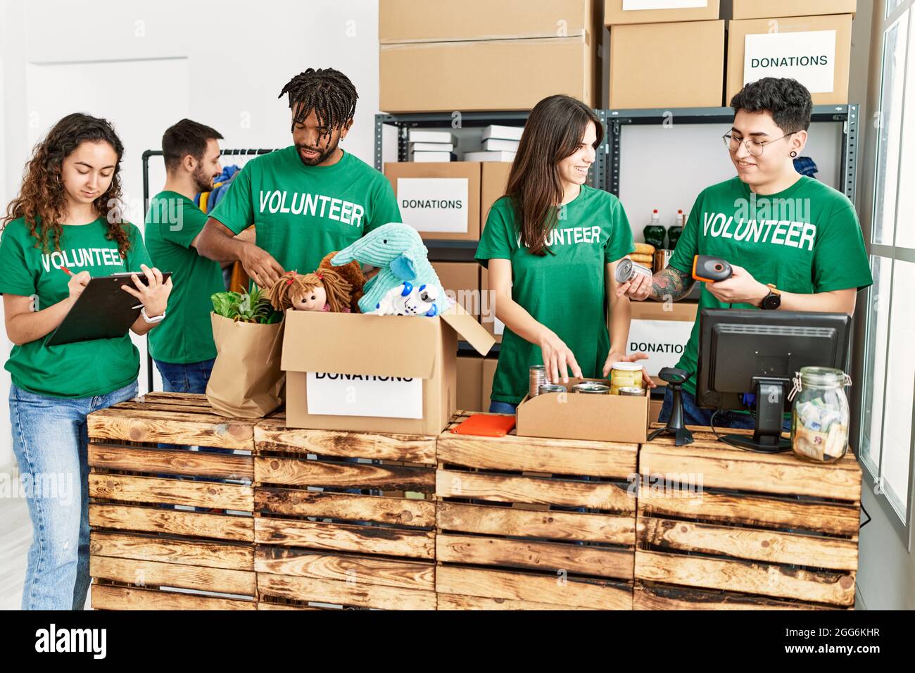 Group of young volunteers smiling happy working at charity center Stock ...