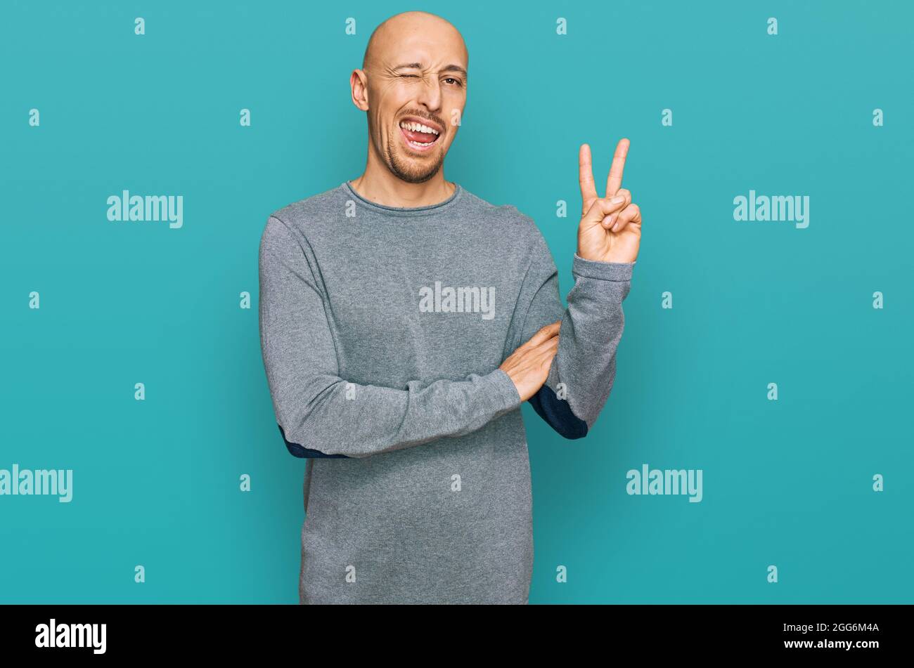 Bald man with beard wearing casual clothes smiling with happy face ...