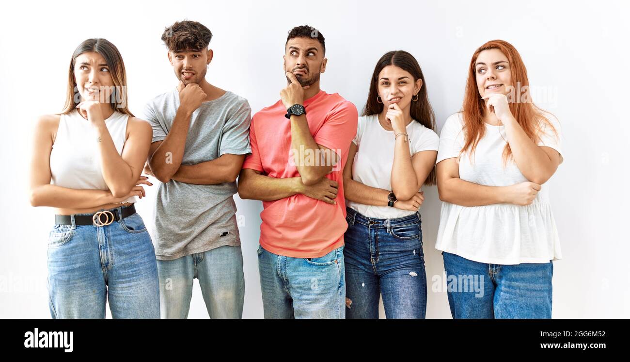 Group of young friends standing together over isolated background ...