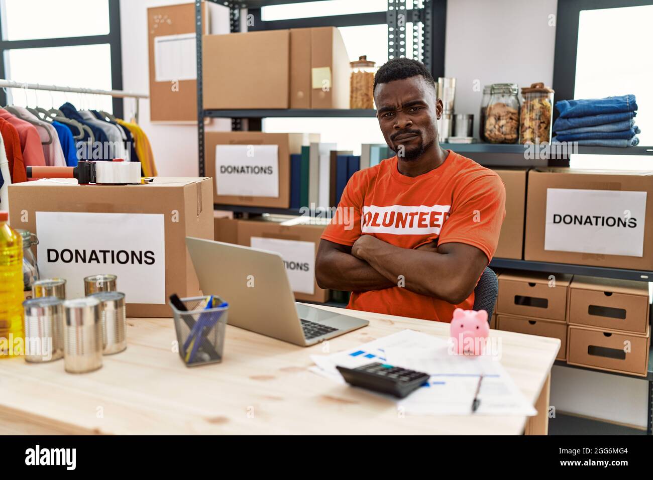 Young african man working as volunteer t shirt at donations stand ...