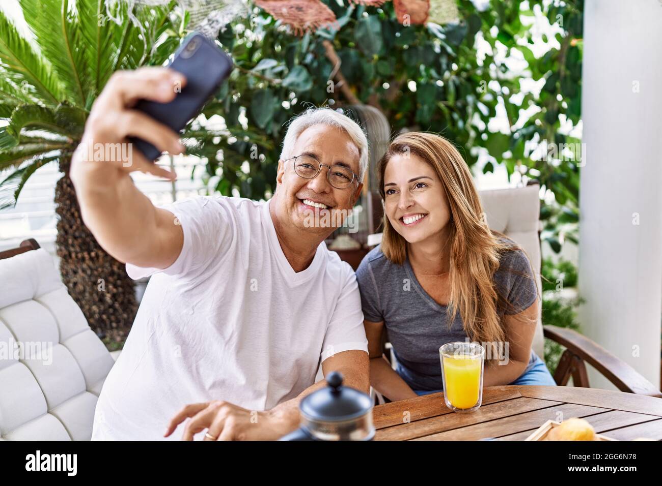 Middle age hispanic couple having breakfast making selfie by the ...