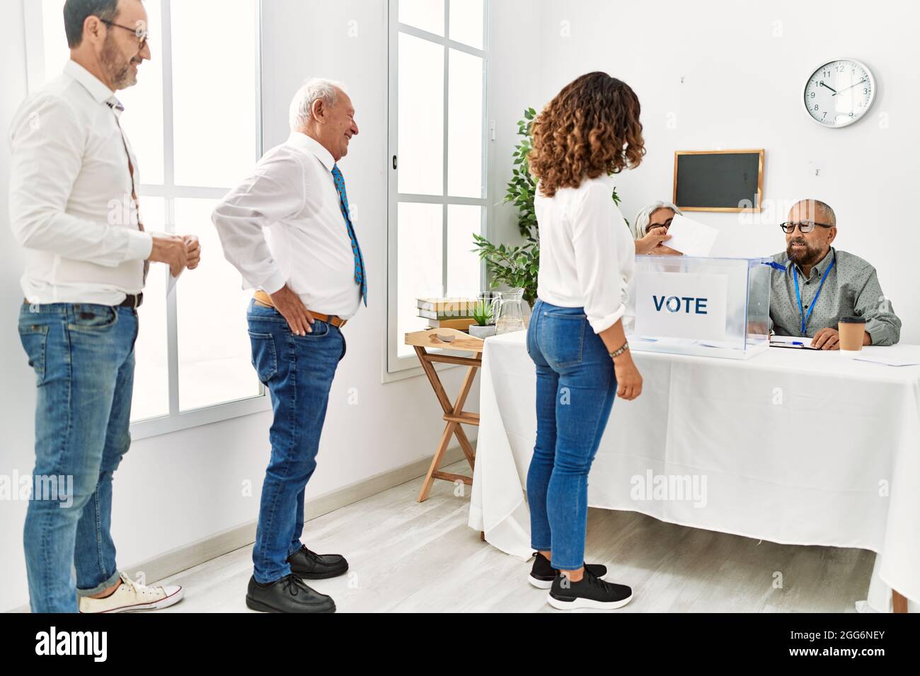 Group of middle age voter people putting vote in ballot standing at ...