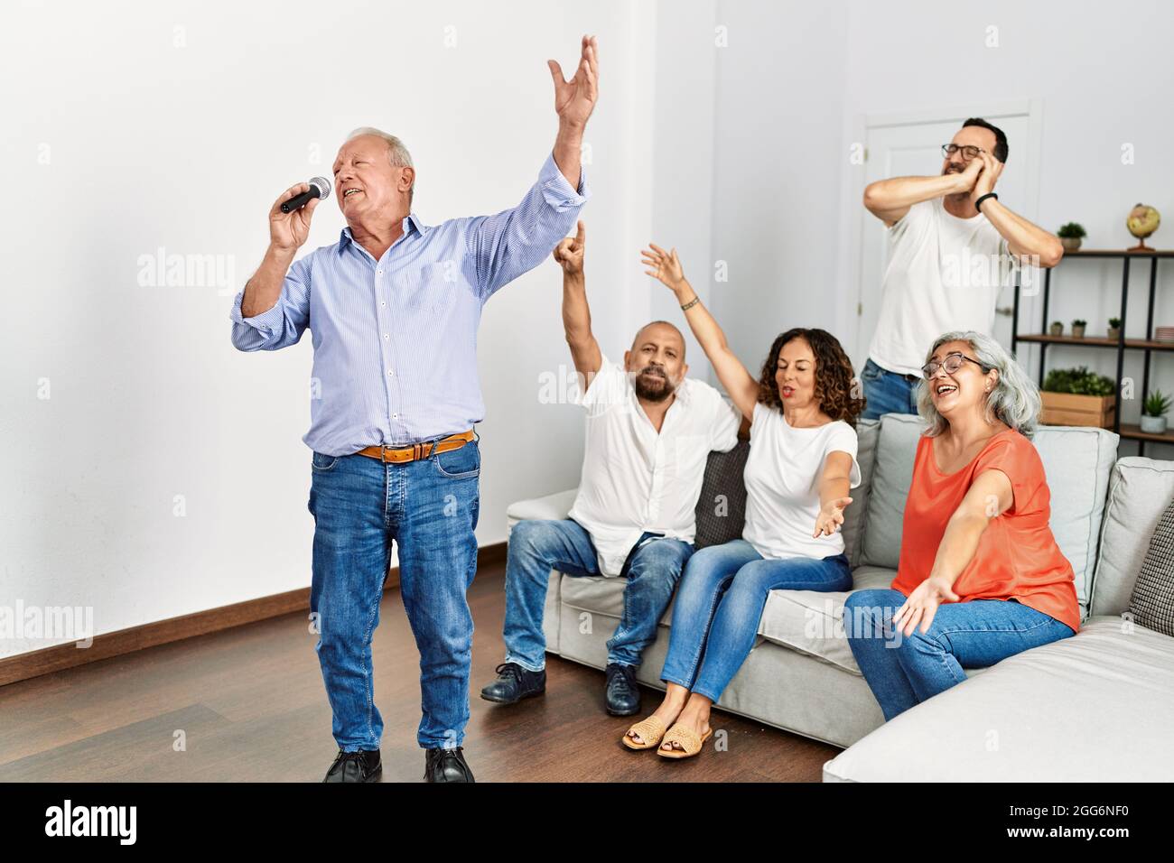 Group of middle age friends having party singing song using microphone ...