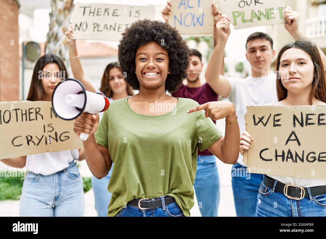 Group of young friends protesting and giving slogans at the street ...