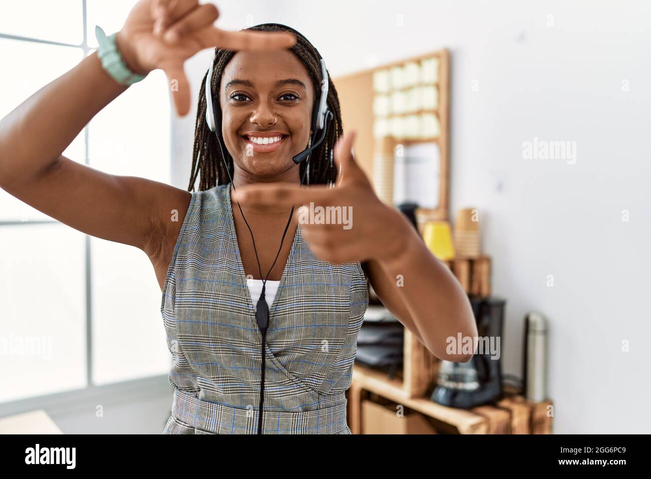 Young african american woman working at the office wearing operator ...
