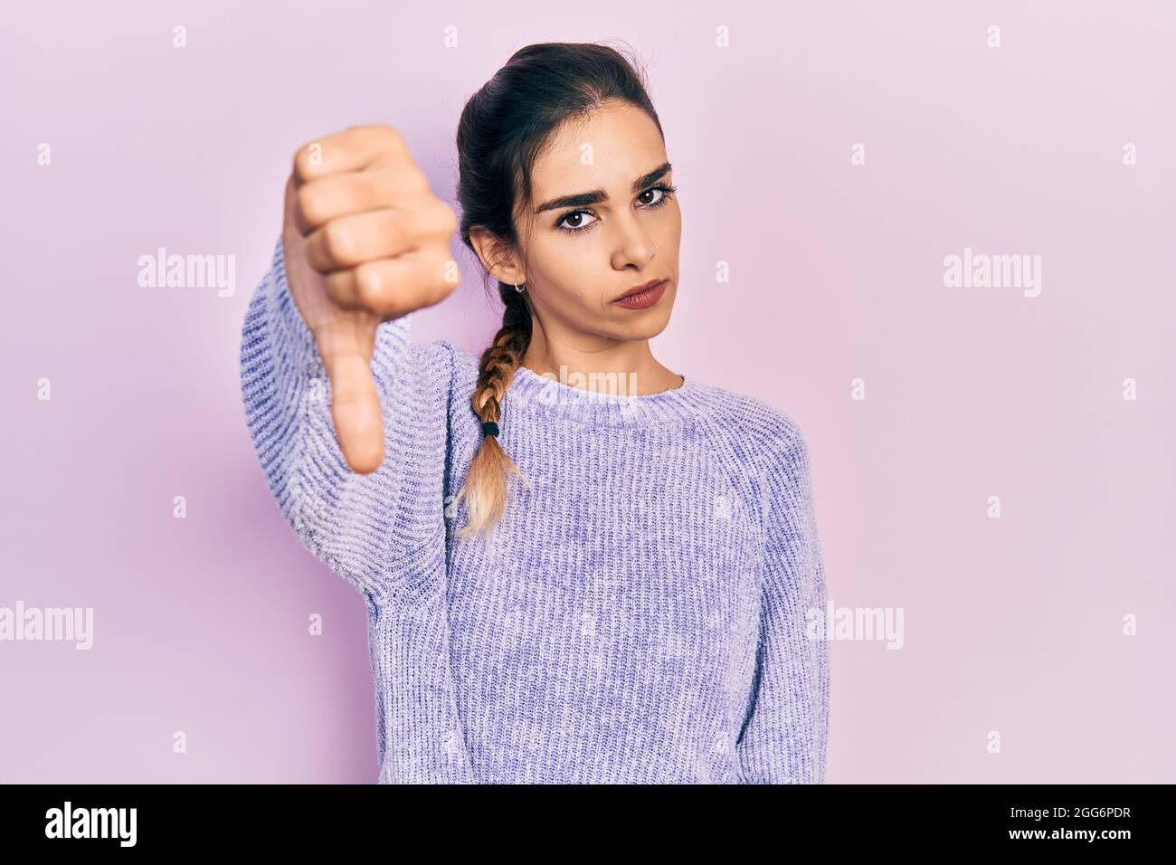Young hispanic girl wearing casual clothes looking unhappy and angry ...