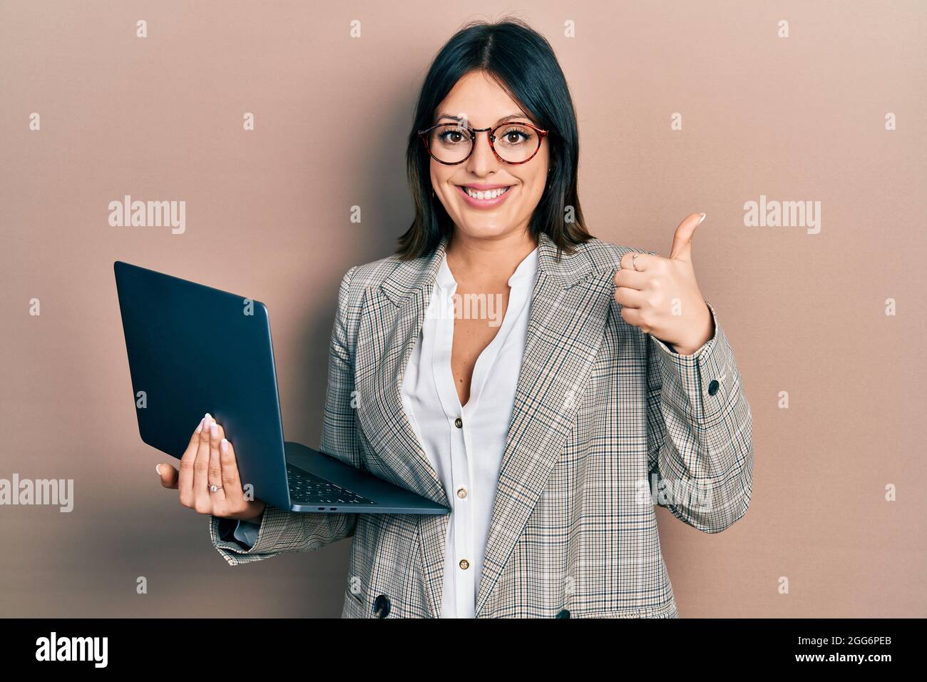 Young hispanic woman working using computer laptop smiling happy and ...