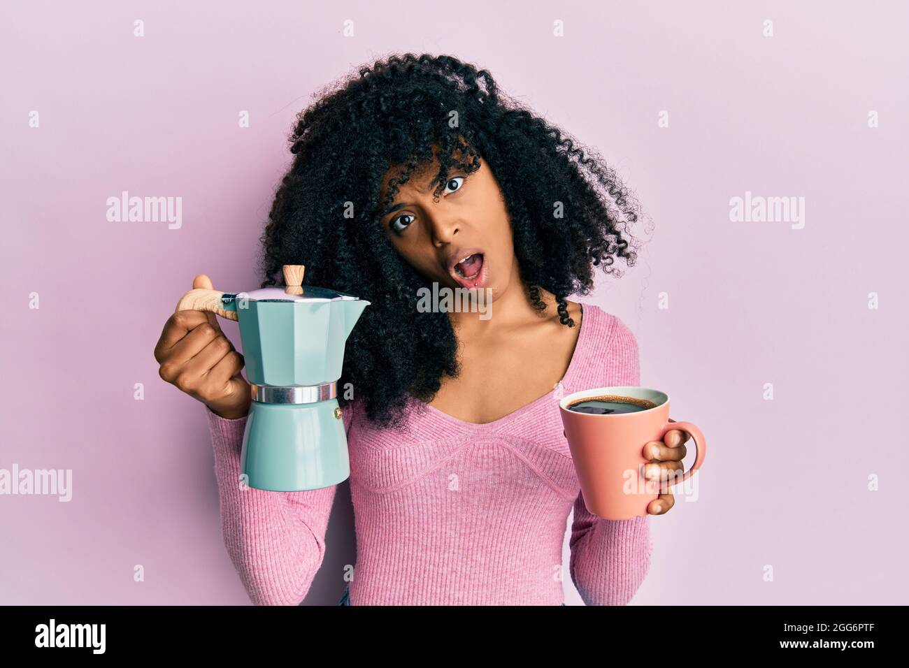 African american woman with afro hair drinking italian coffee in shock ...