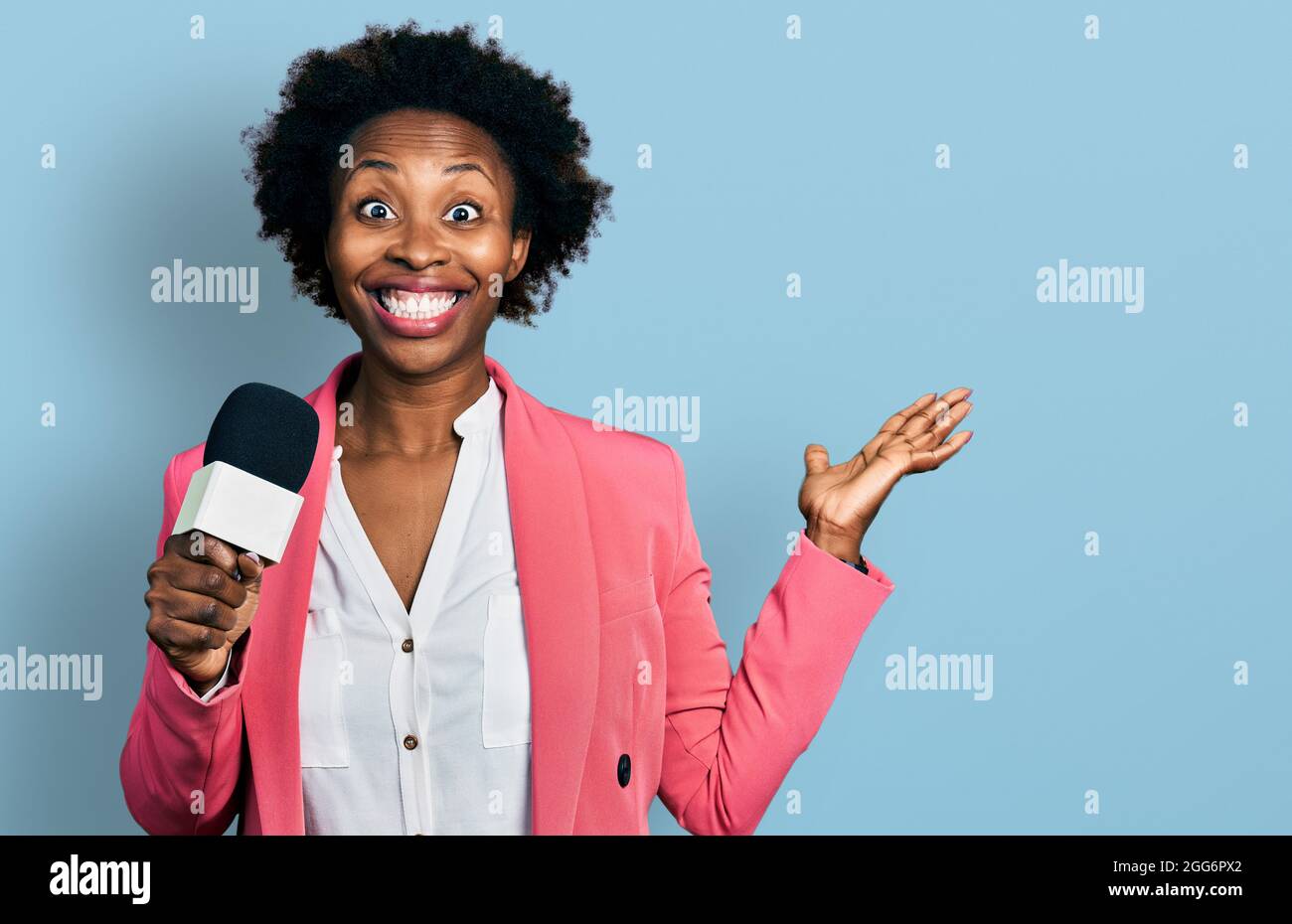 African american woman with afro hair holding reporter microphone ...
