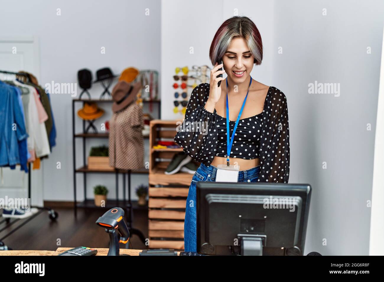 Young caucasian shopkeeper woman smiling happy talking on the ...