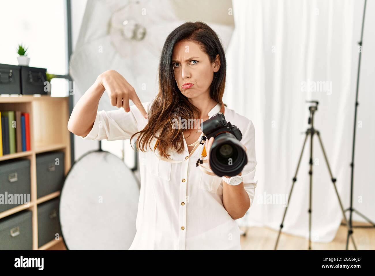 Beautiful caucasian woman working as photographer at photography studio ...