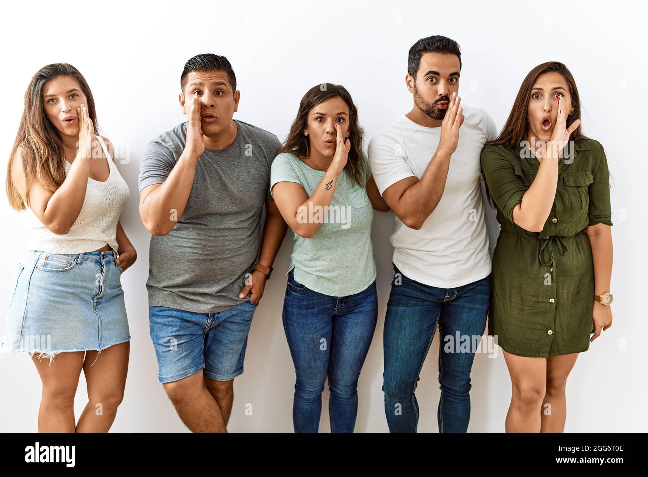 Group of young hispanic friends standing together over isolated ...