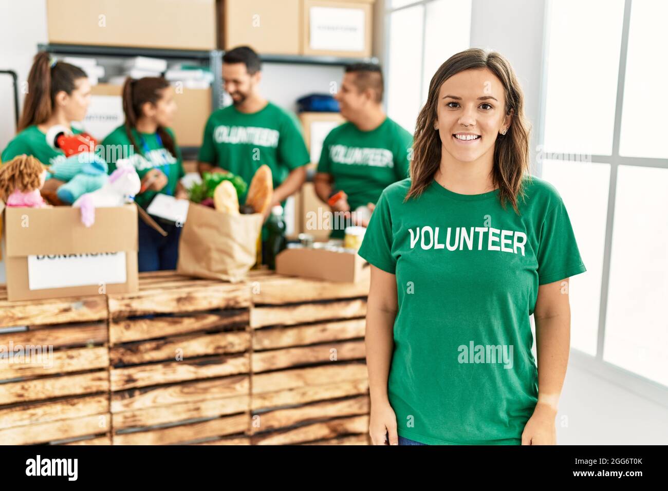 Group of young volunteers smiling happy working at charity center Stock ...
