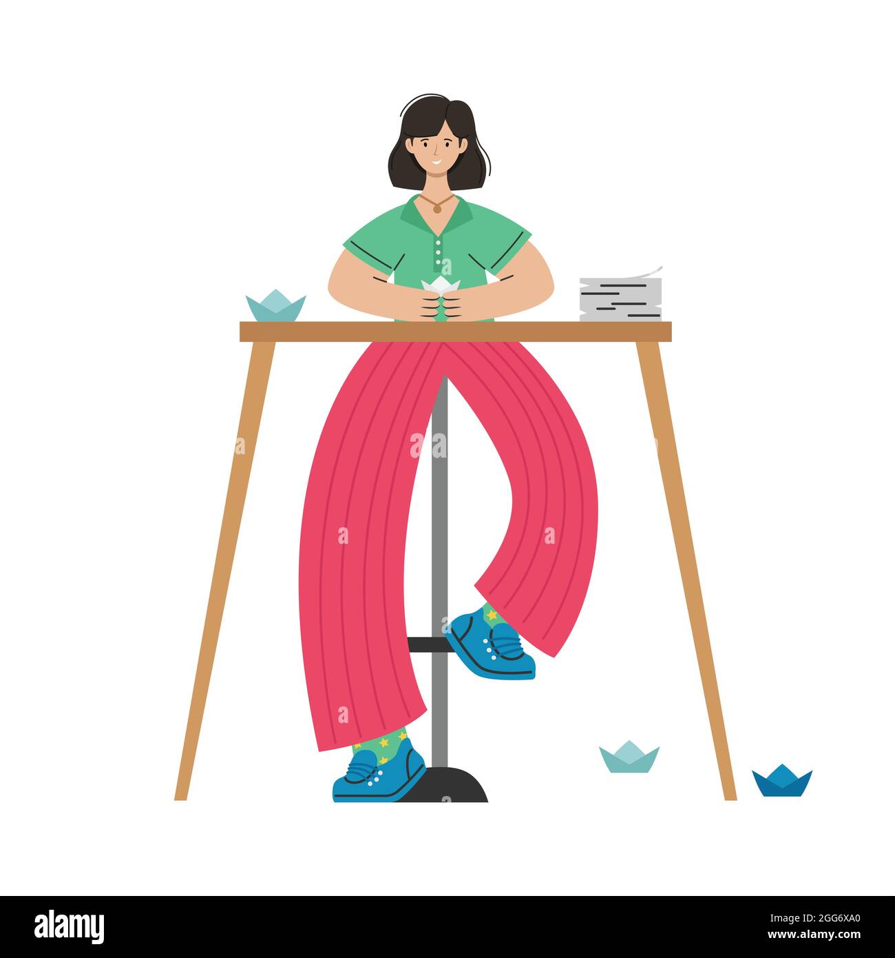 A girl makes origami out of paper at the table. Creative activity Stock ...