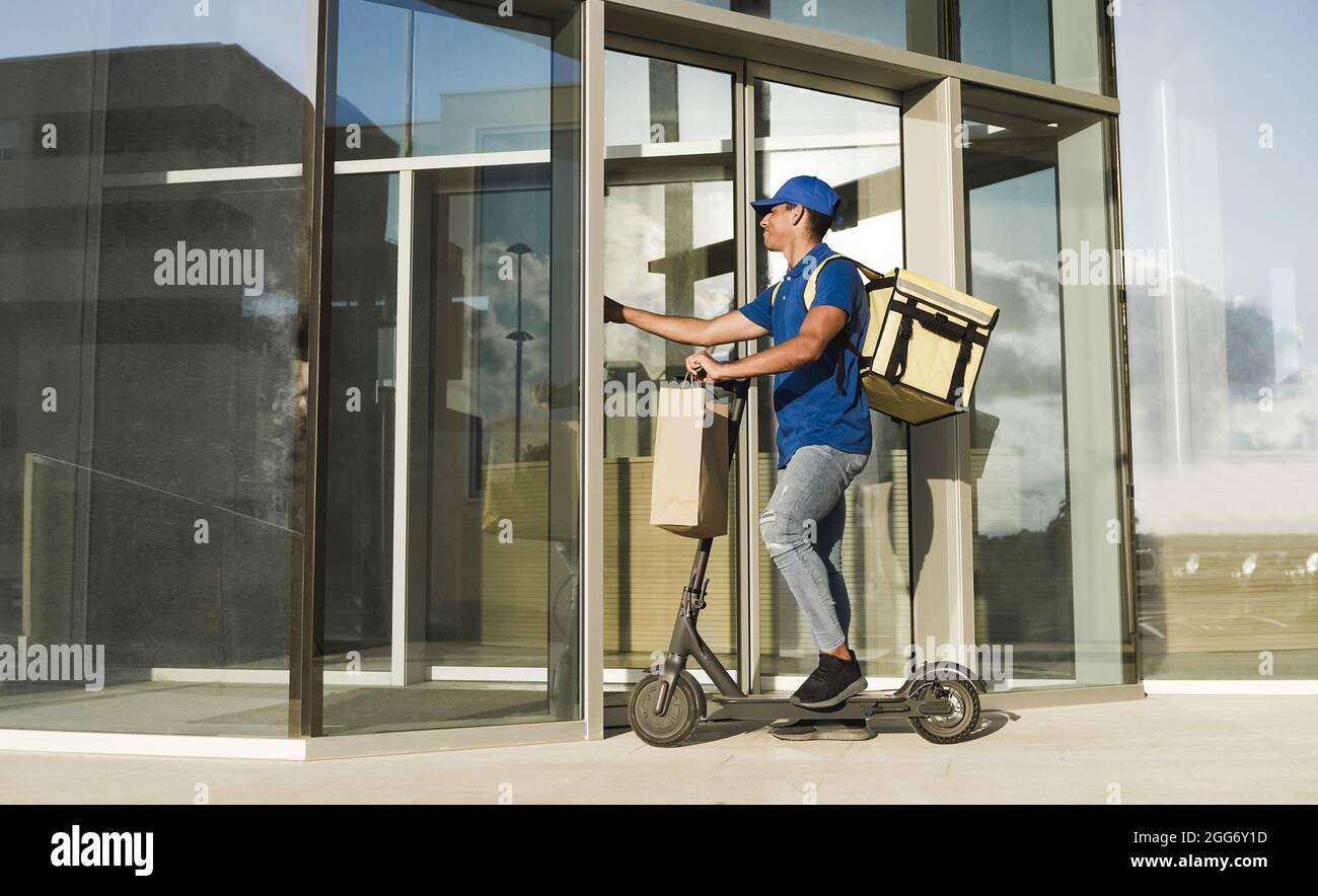 African delivery man doing fast food deliver with thermal backpack and ...