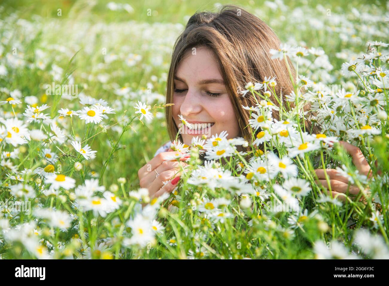 beauty of nature. woman in camomile field. summer flower meadow. beautiful lady among chamomile ...