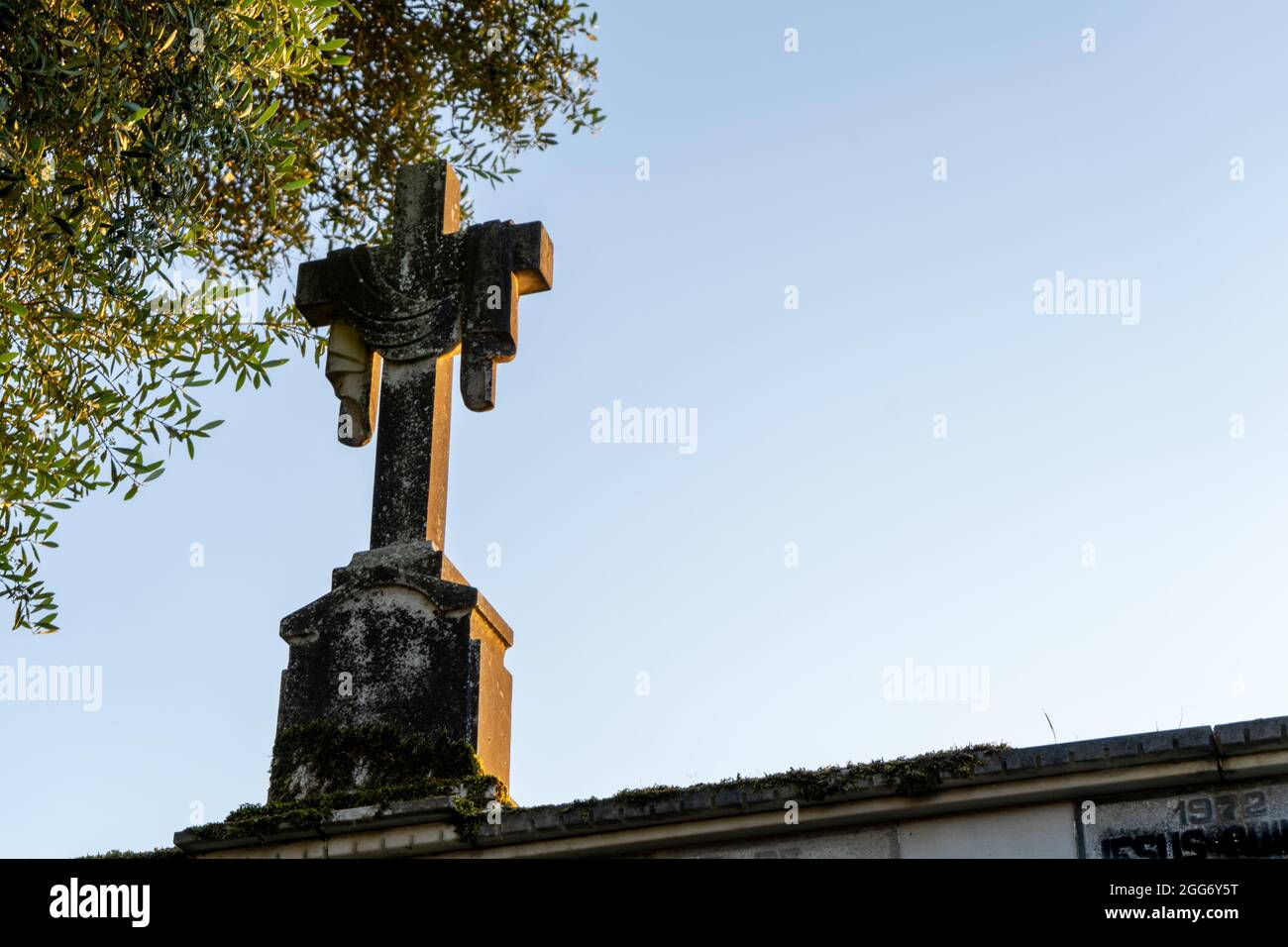 strange cross in a cemetery at sunset Stock Photo - Alamy