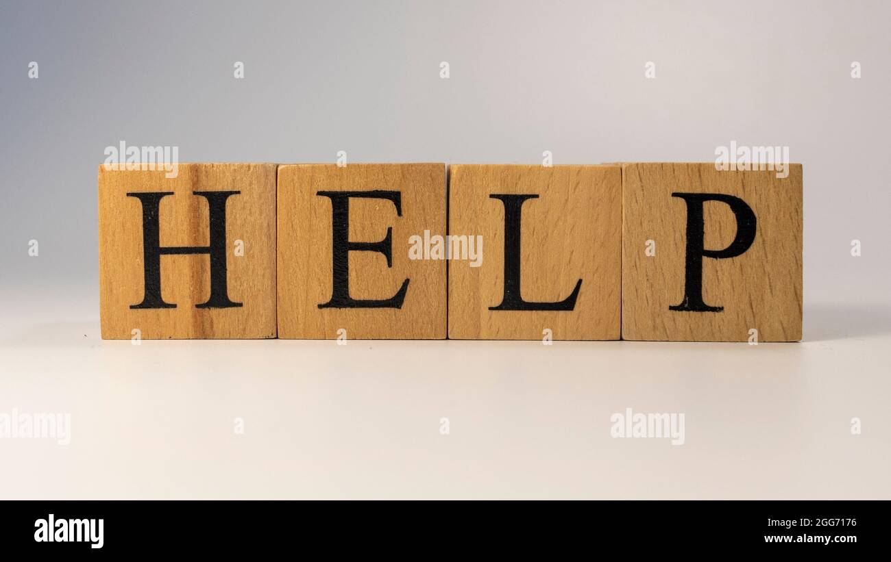 The word HELP was created from wooden cubes Stock Photo - Alamy