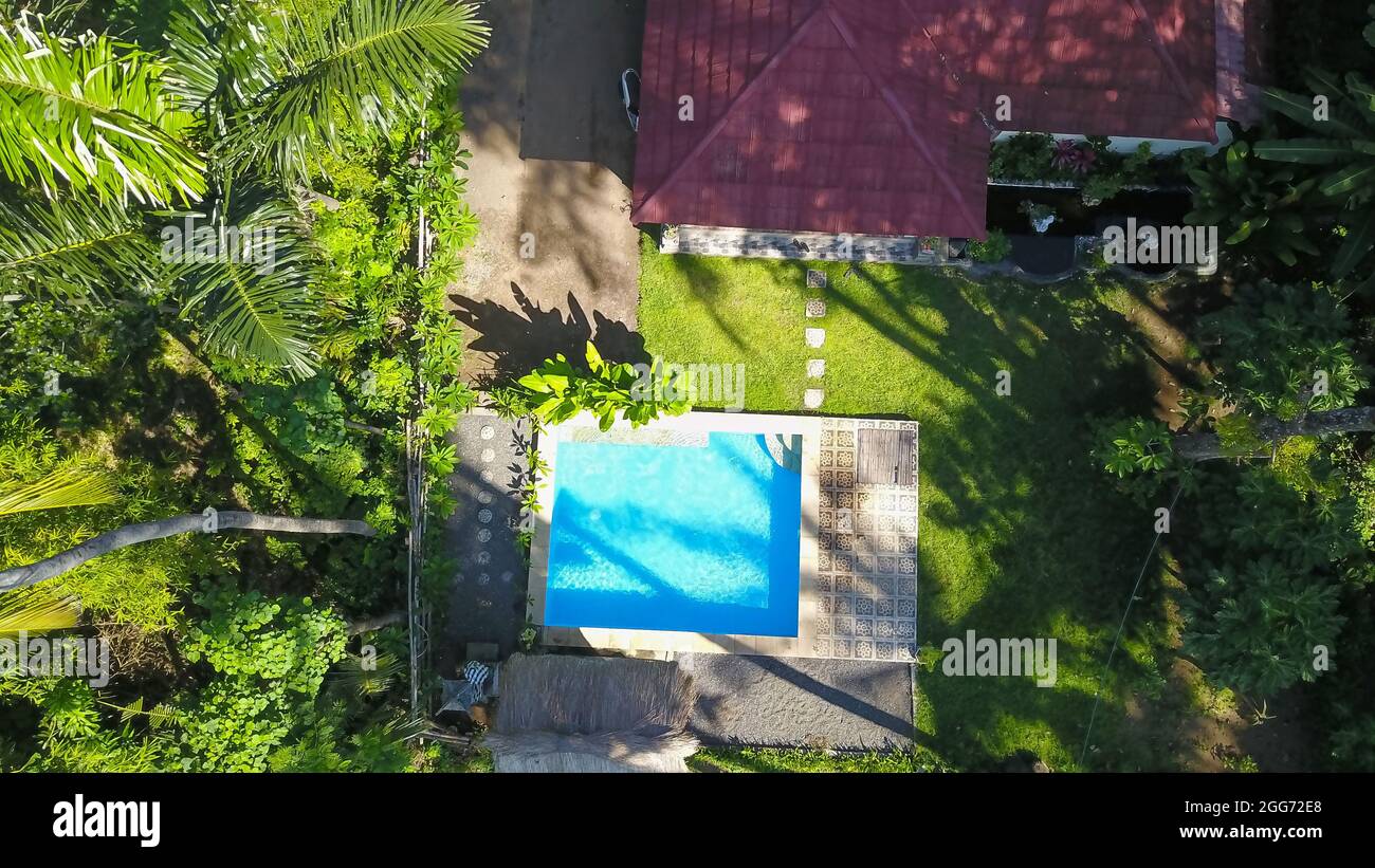 Aerial view of a house with pool surrounded by textured rice fields ...