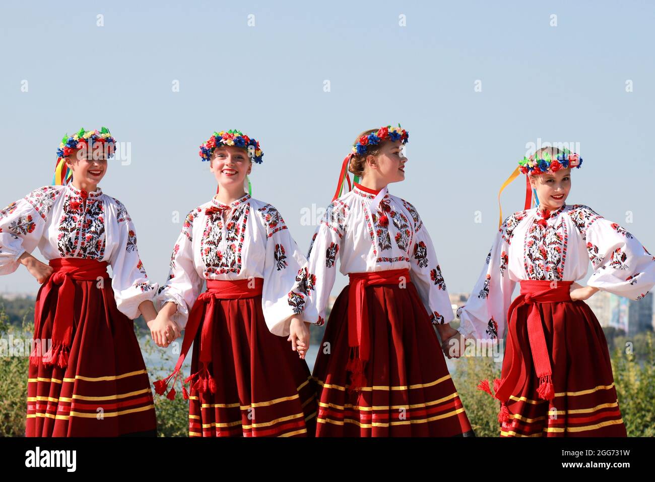 Young girls dance the national Ukrainian dance in folk costumes ...