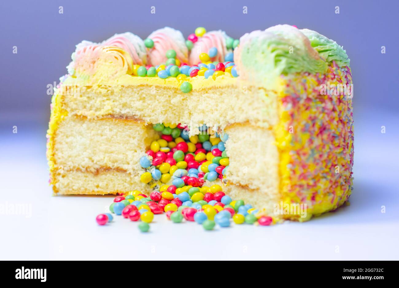 Madeira sponge coated with yellow colour frosting, layered with plum ...