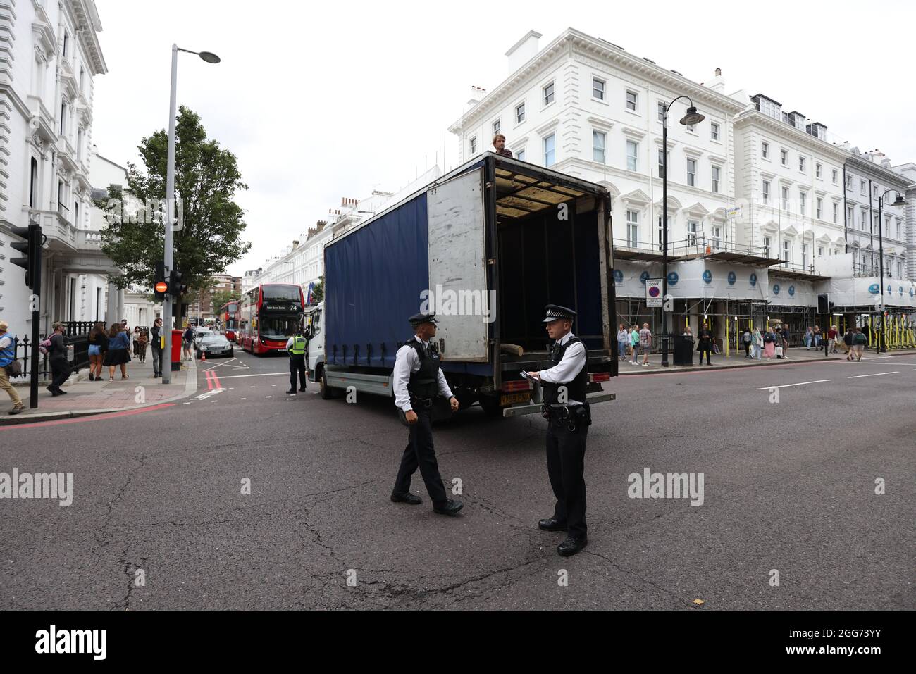Police inspect a lorry parked across a junction by demonstrators on the ...
